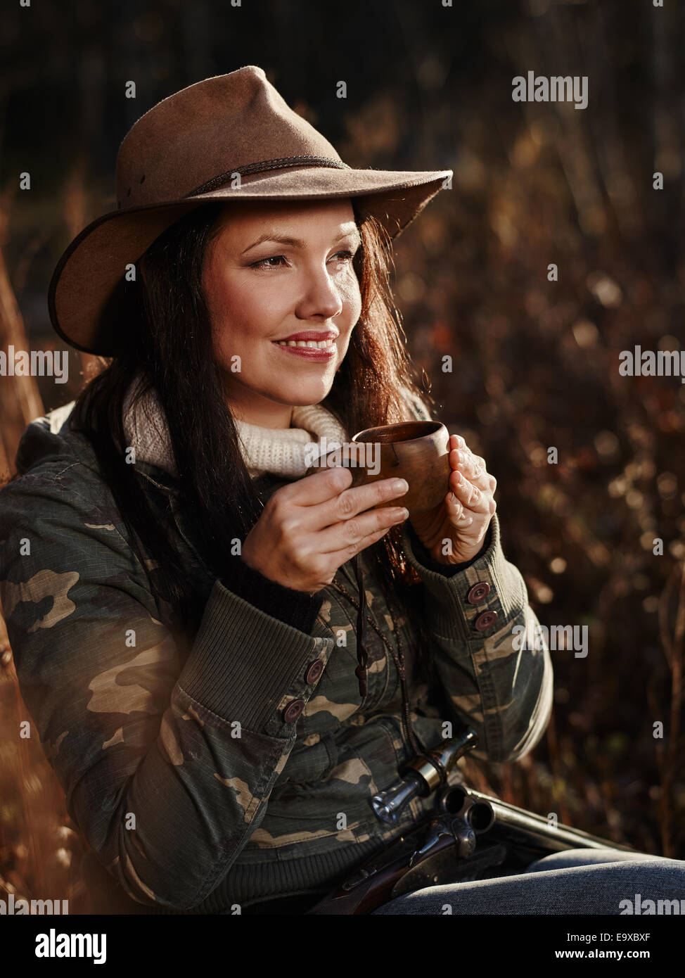 Waterfowl hunting, the female hunter having a coffee break, autumnal ...