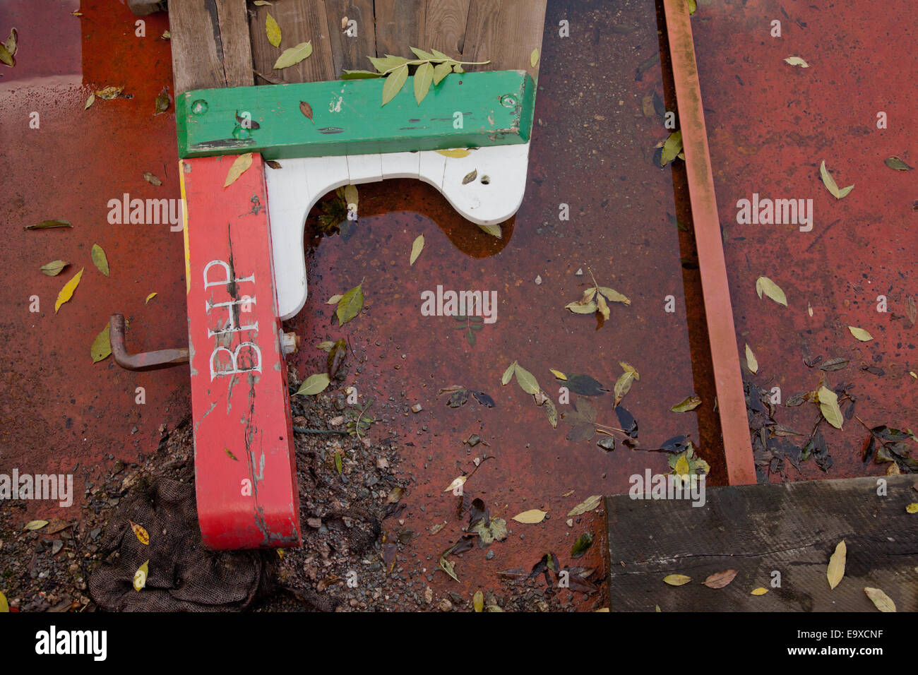 Canal boat tiller or rudder in water in the bottom of an old canal boat ...