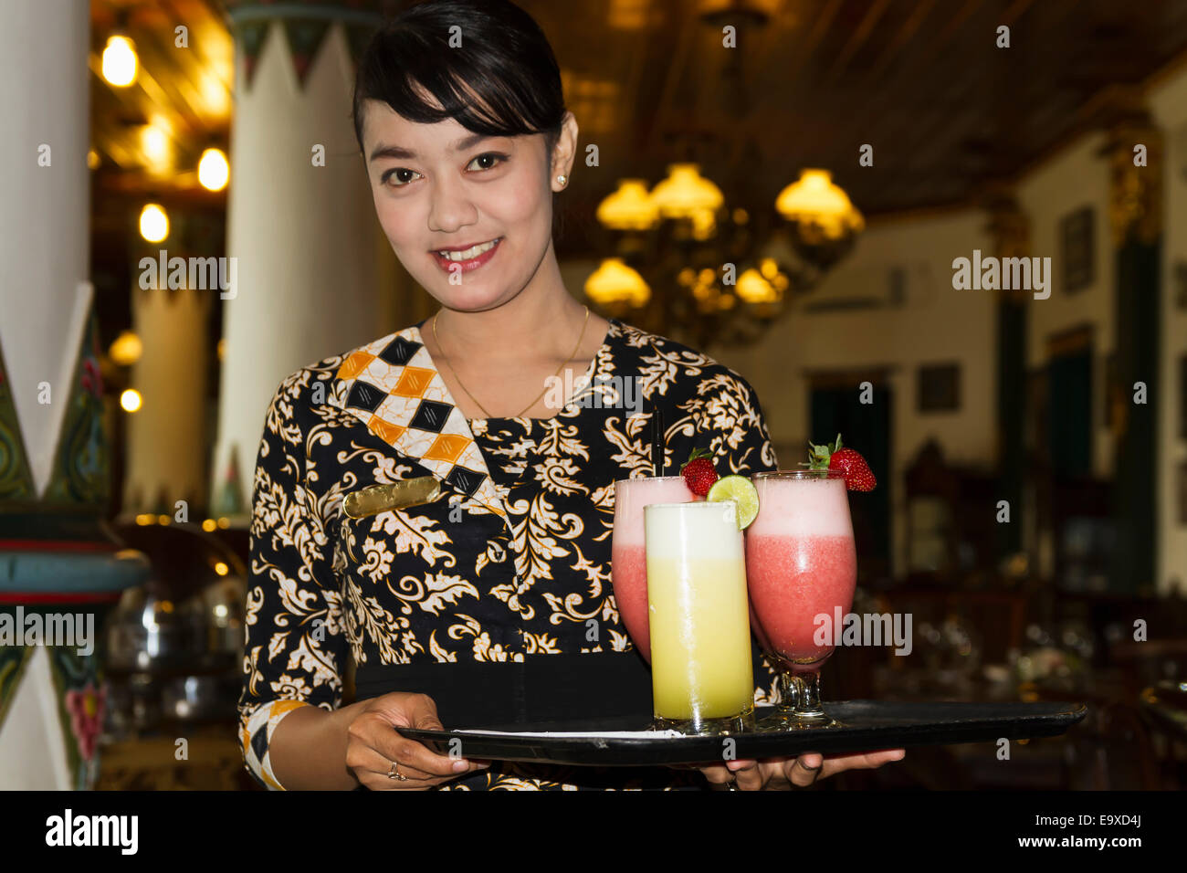 Waitress holding drinks at the Sekar Kedaton Restaurant, Yogyakarta ...