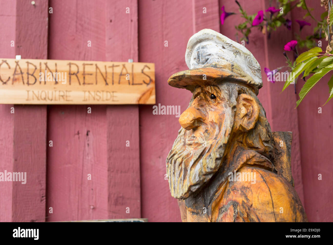 Close up of a folk art carving of a sea captain along the boardwalk ...