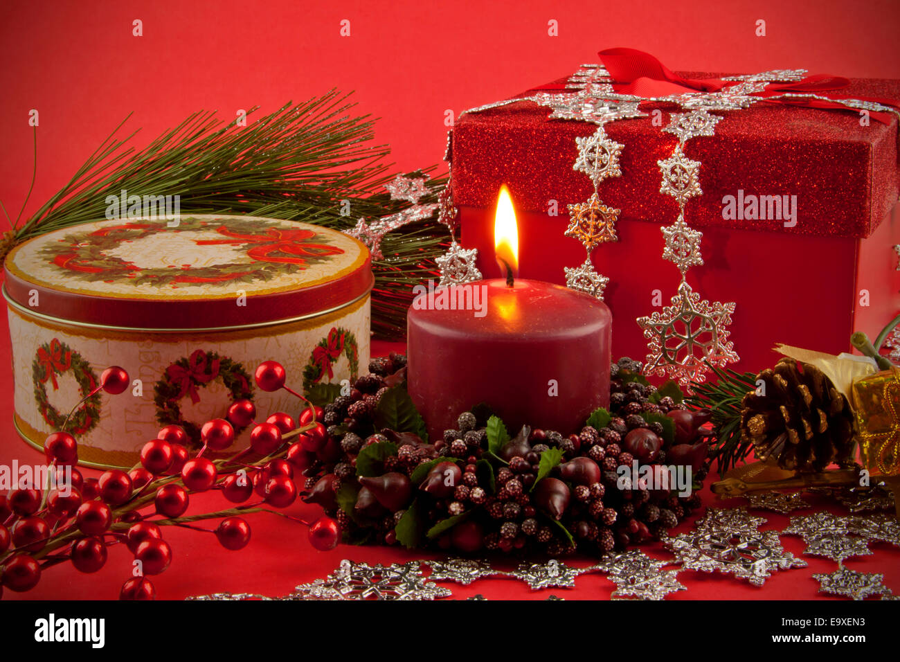 A holiday still life with a lit candle and gifts Stock Photo - Alamy