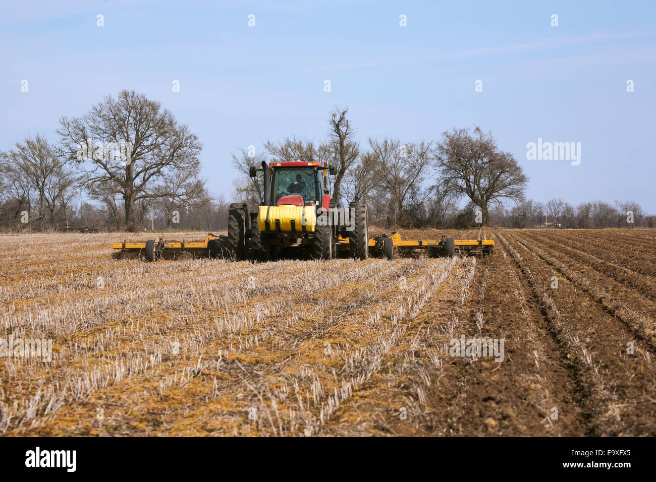 A Case IH tractor and field implement prepare a field in late Spring ...