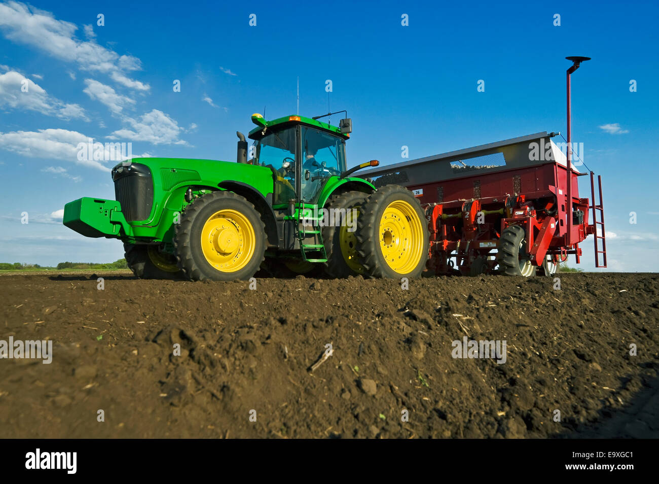 Agriculture A John Deere Tractor And Spudnik Planter Planting