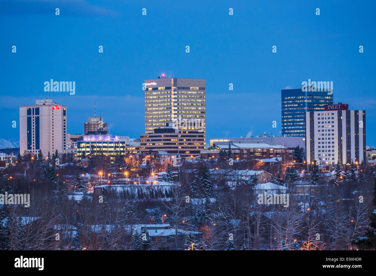 The Anchorage skyline and Chugach Mountains at twilight, winter ... The Anchorage skyline and Chugach Mountains at twilight, winter ...