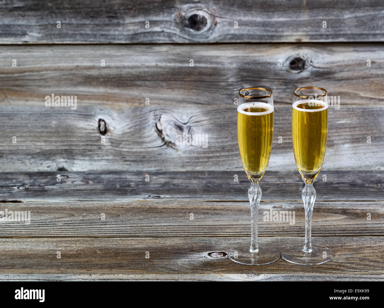 Golden champagne in elegant glasses on rustic wood Stock Photo - Alamy