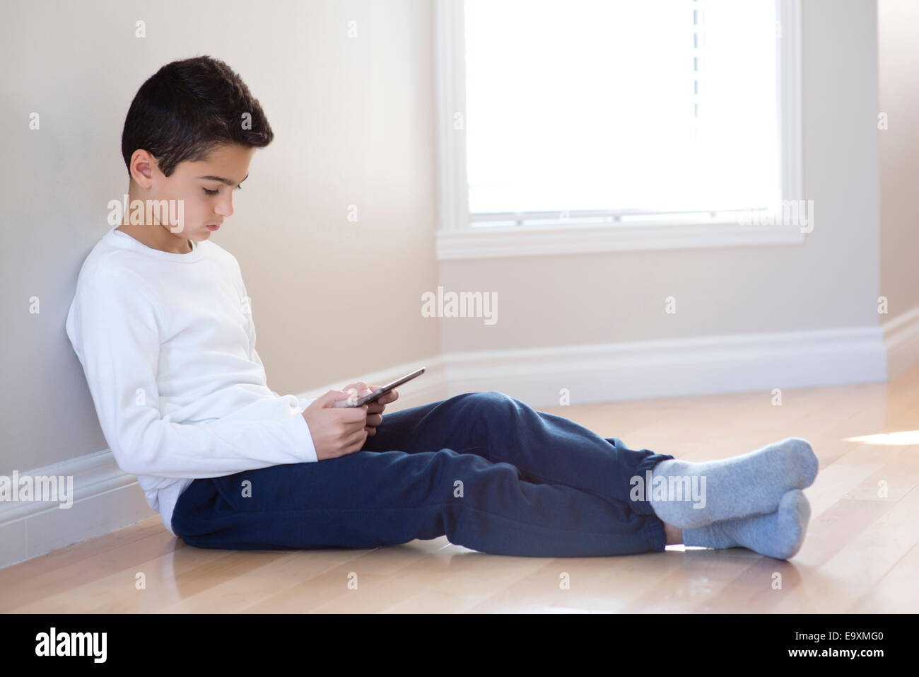 Young boy sitting with an iPad tablet computer Stock Photo - Alamy