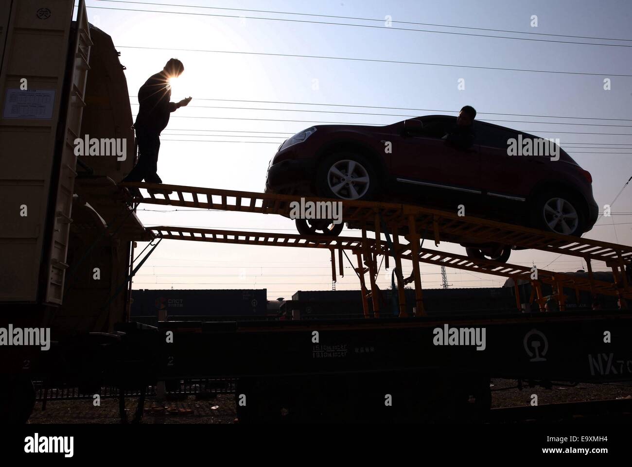 Beijing, China. 4th Nov, 2014. Workers load a car onto a carriage at ...