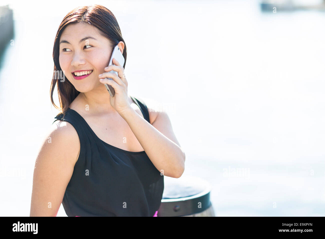 A young Asian woman using a smartphone to communicate Stock Photo - Alamy