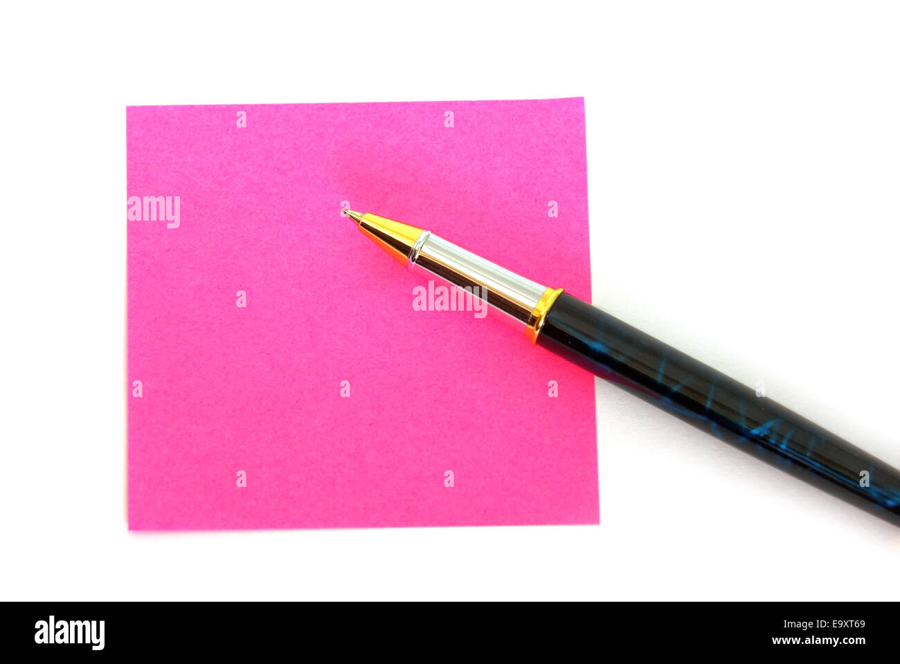 Making a note on a pink post it Stock Photo - Alamy