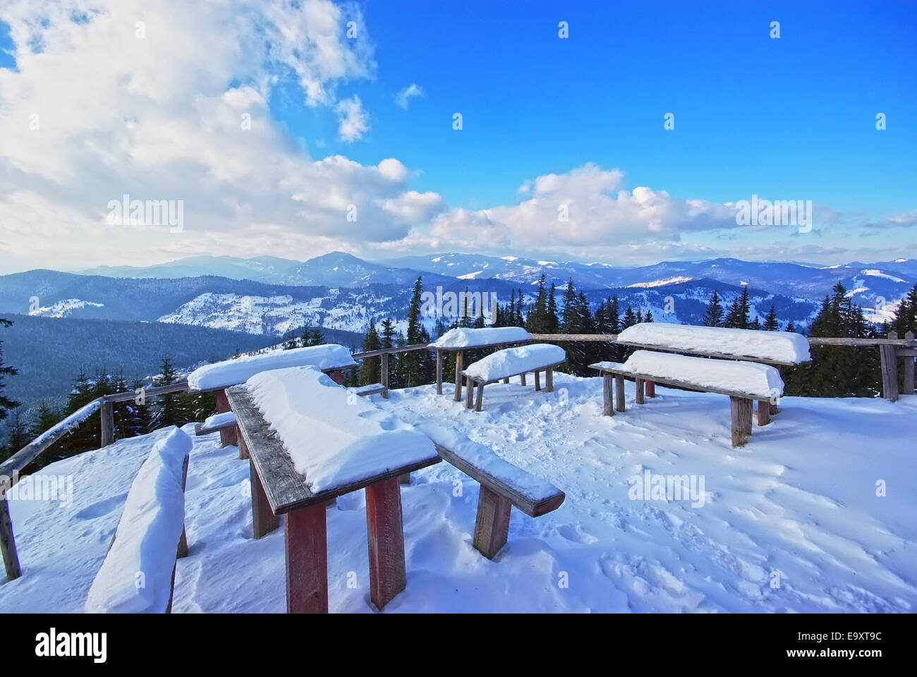 Winter scene: tables and seats with snow in mountains Stock Photo - Alamy
