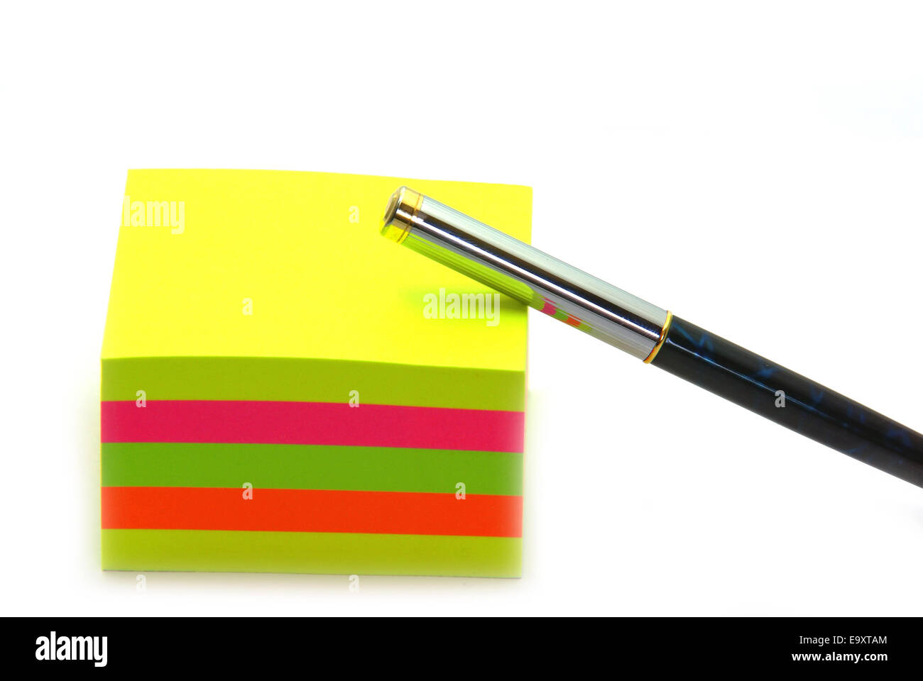 Stack of post its and a pen on a white background Stock Photo - Alamy
