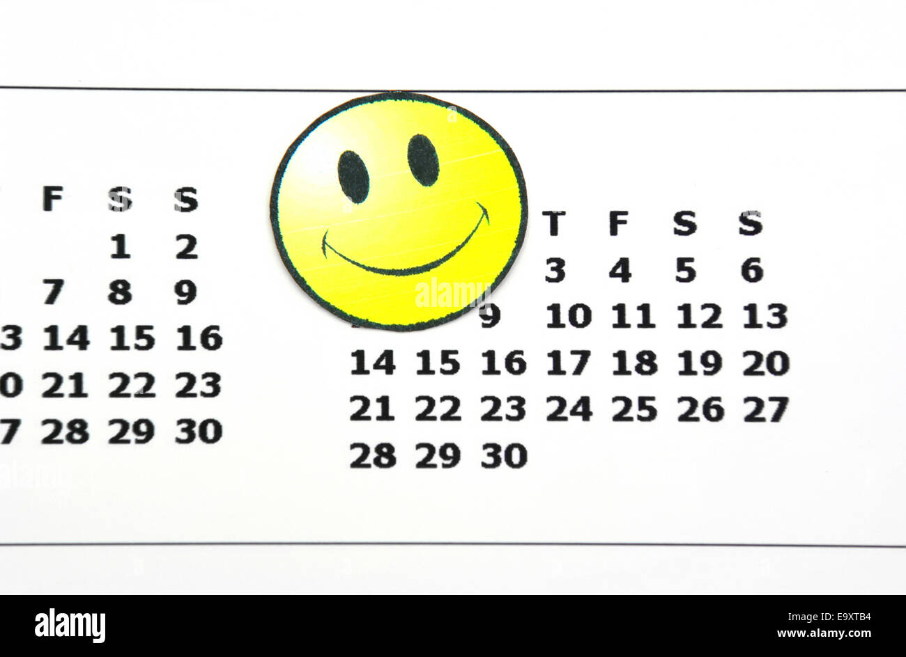 Happy face on a calendar, close image Stock Photo - Alamy