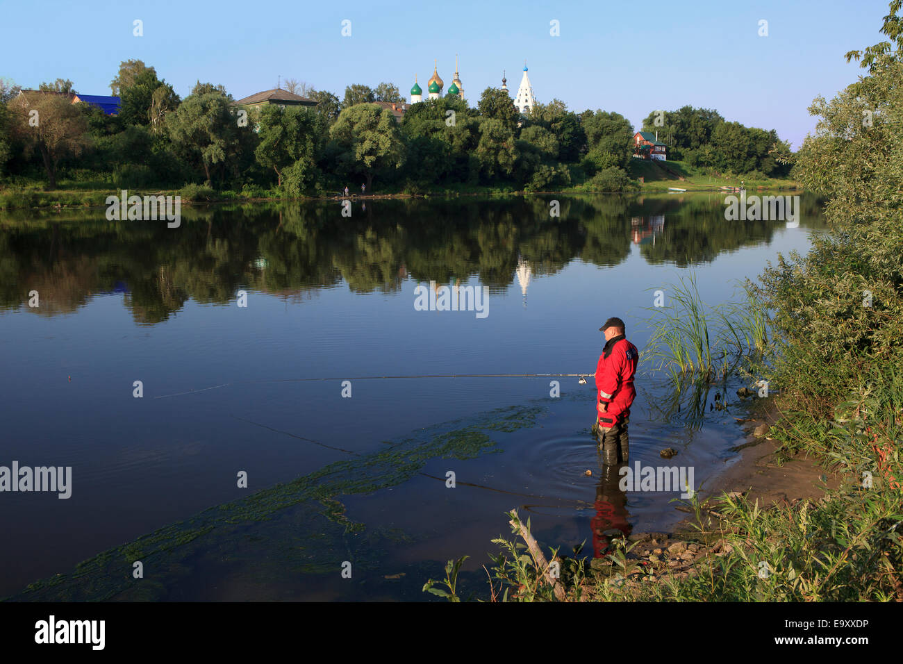 Man fishing in the Moskva River across from the Old Town in Kolomna ...