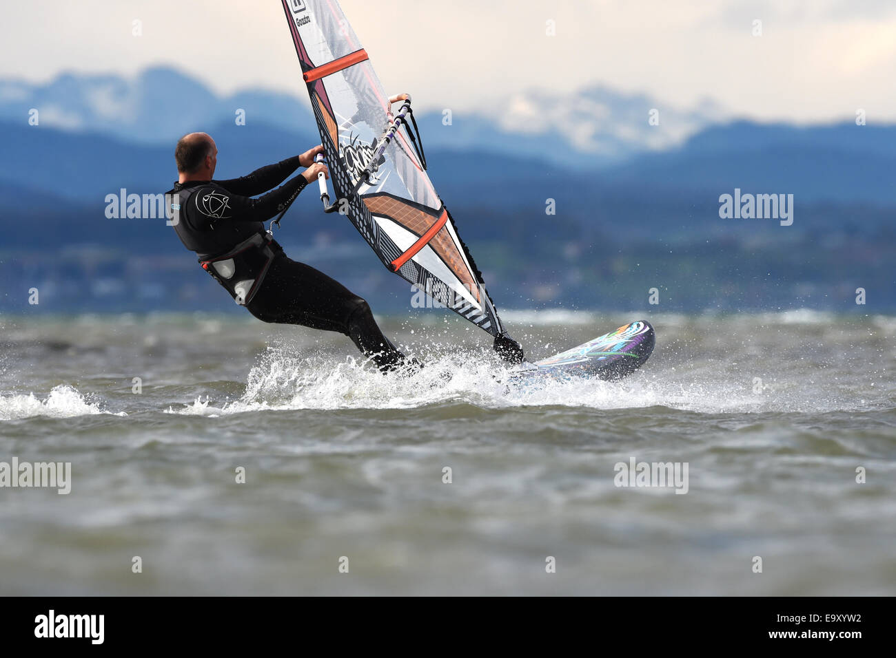 A surfer races over the waves in a heavy wind on Lake Constance in ...