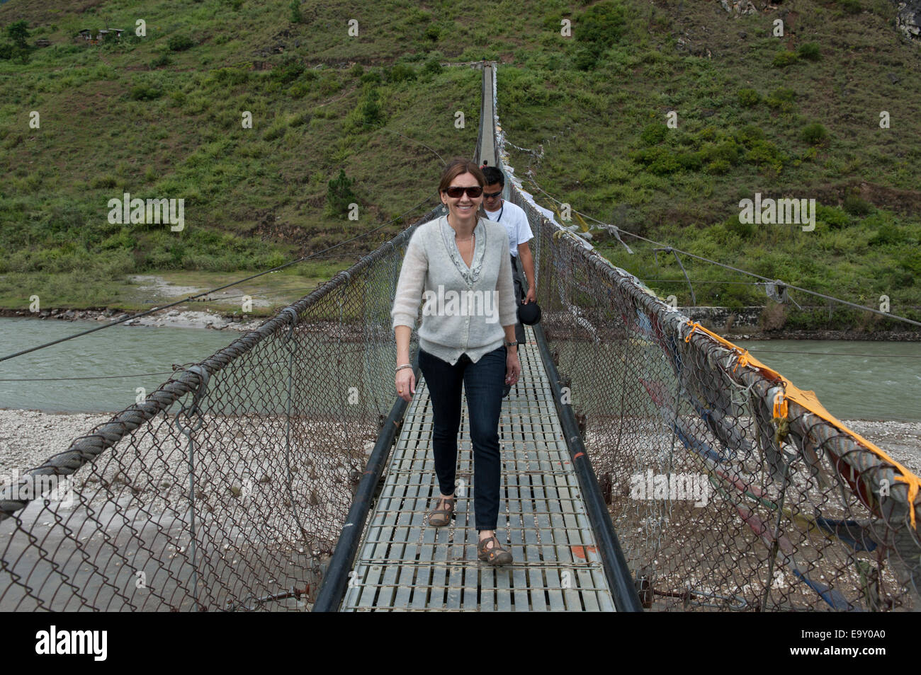 Tourists crossing the bridge across Puna Tsang River, Punakha District ...