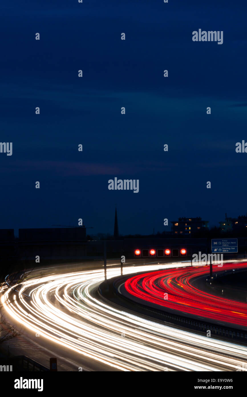 Cars at night on a highway. Rope lights and illuminated signs Stock ...