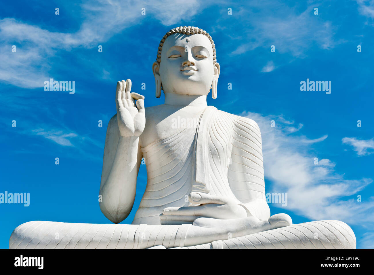 Theravada Buddhism, white statue of Buddha seated in the lotus position ...