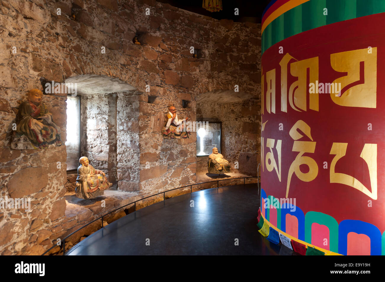 Room with a Tibetan prayer wheel and Buddha statues, Messner Mountain ...