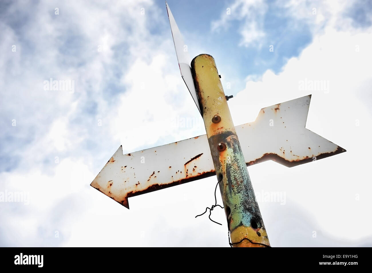 Rusty arrow signpost on a rusty pole Stock Photo - Alamy