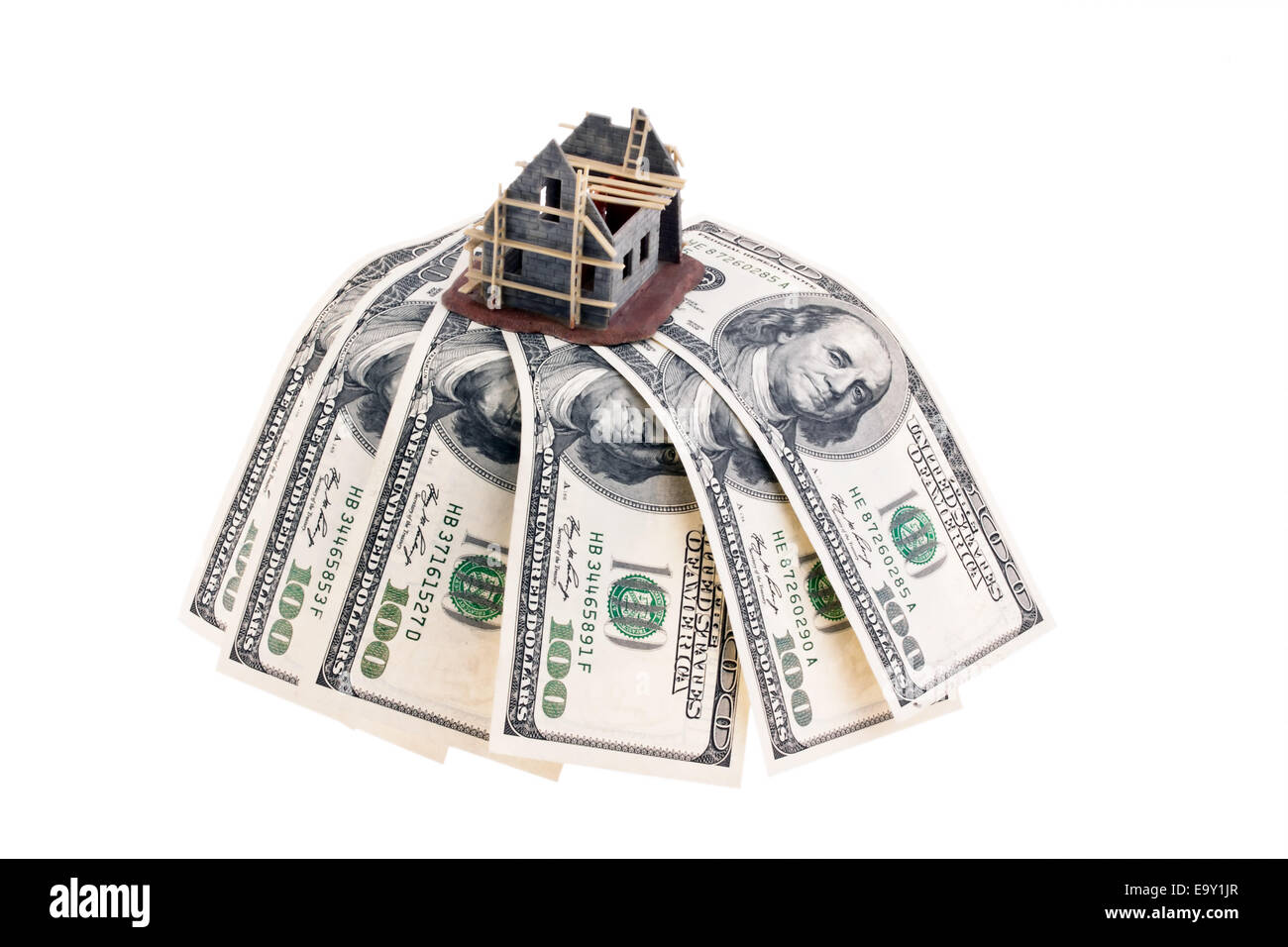 Many dollar bills and shell house on a white background Stock Photo - Alamy