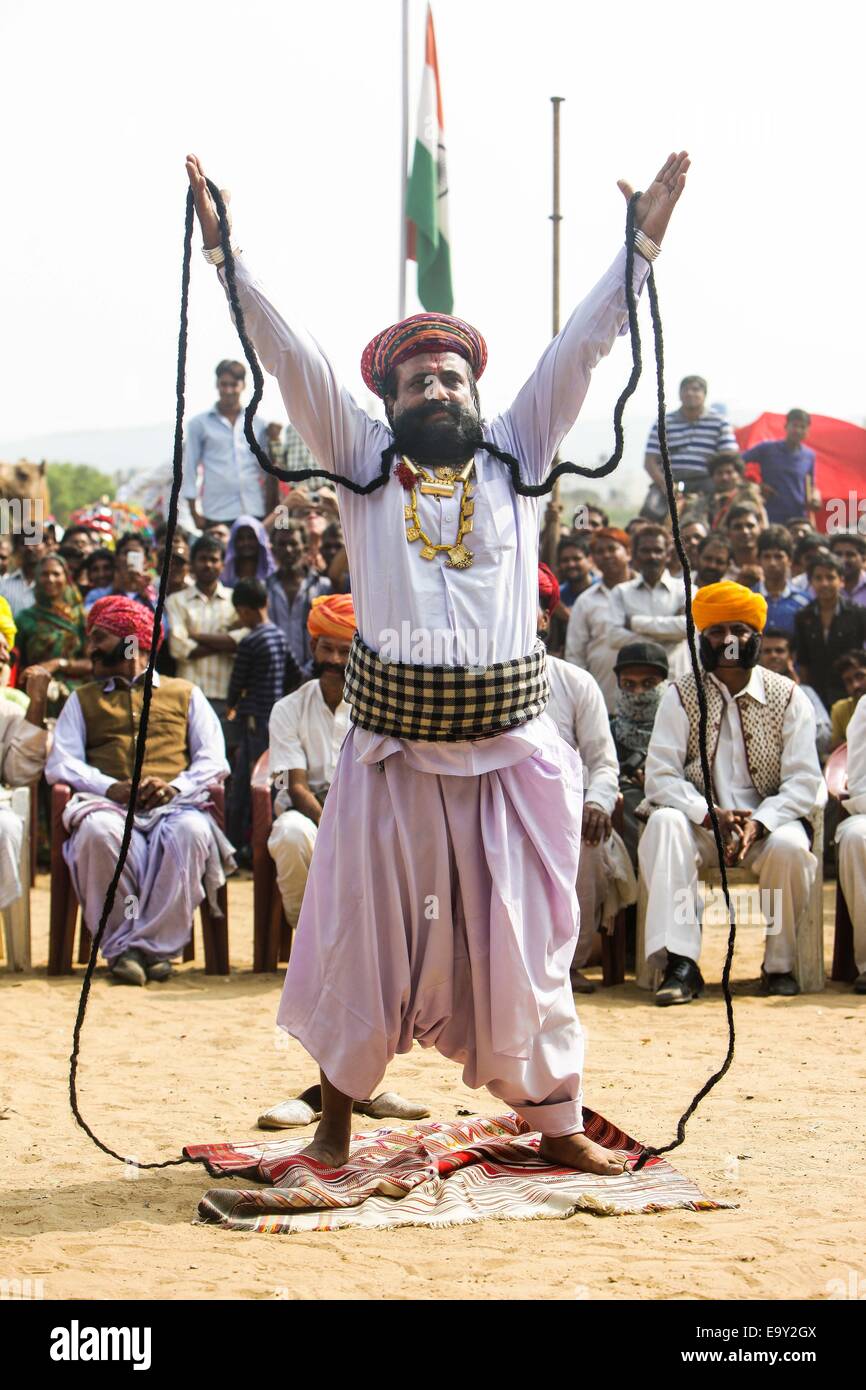 Rajasthan, India. 4th Nov, 2014. A participant shows his moustache at a ...