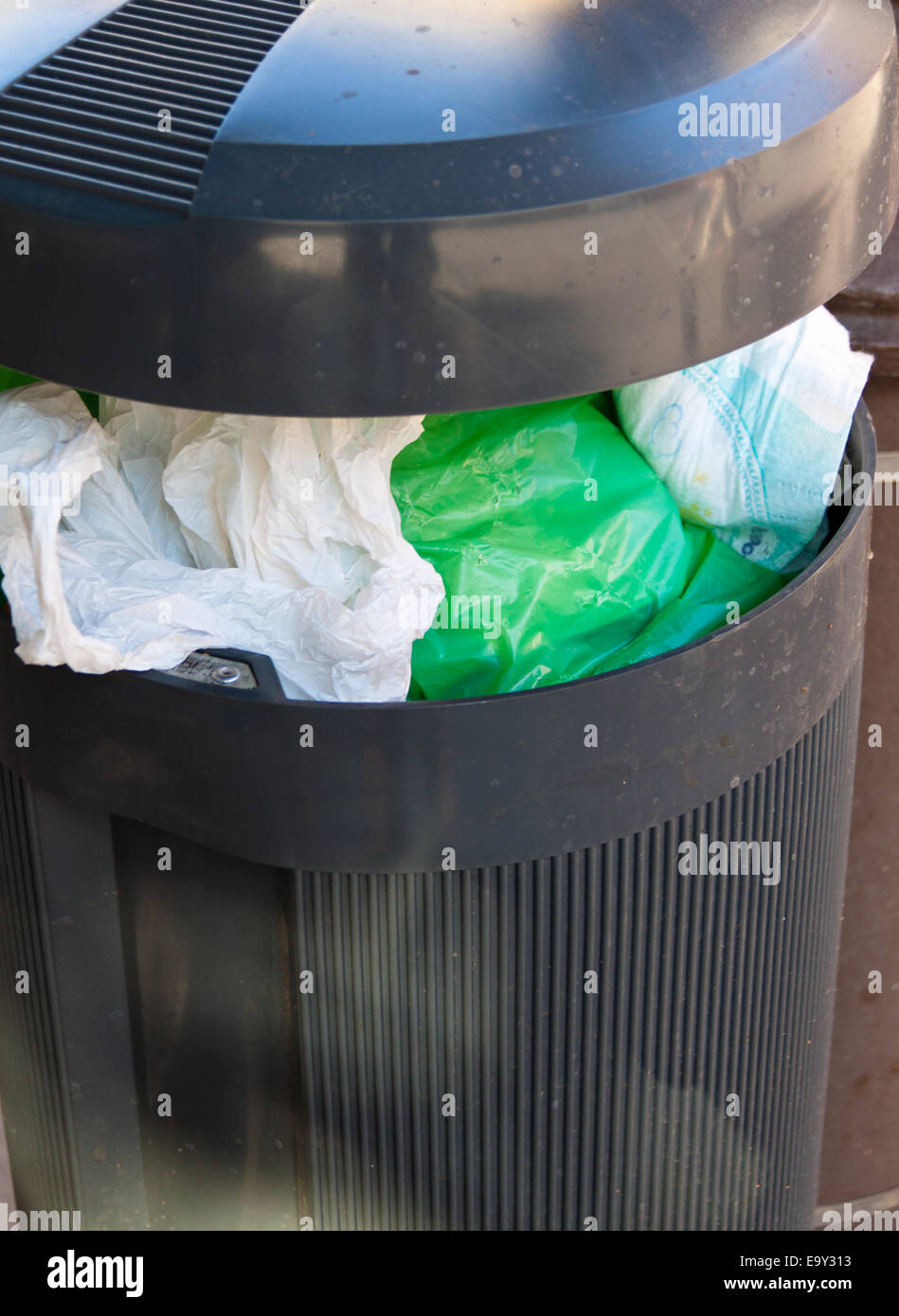 A waste basket with plastic waste in a city Stock Photo - Alamy