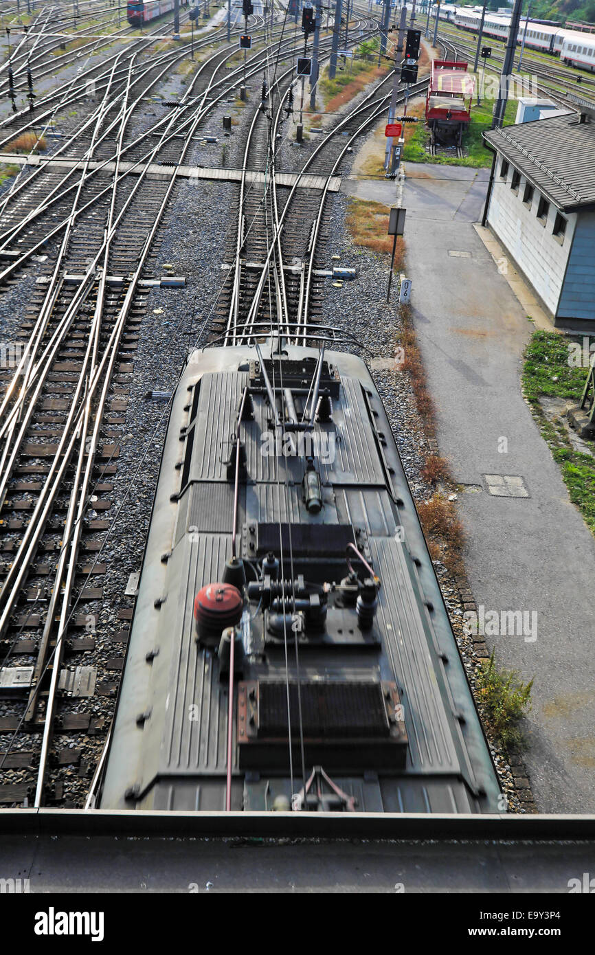 An electric locomotive travels on the rails of a railroad Stock Photo ...