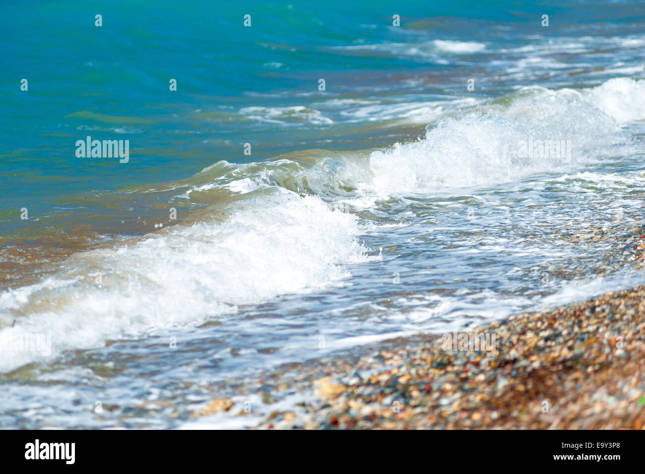 pebble beach and small waves of the Aegean Sea Stock Photo - Alamy