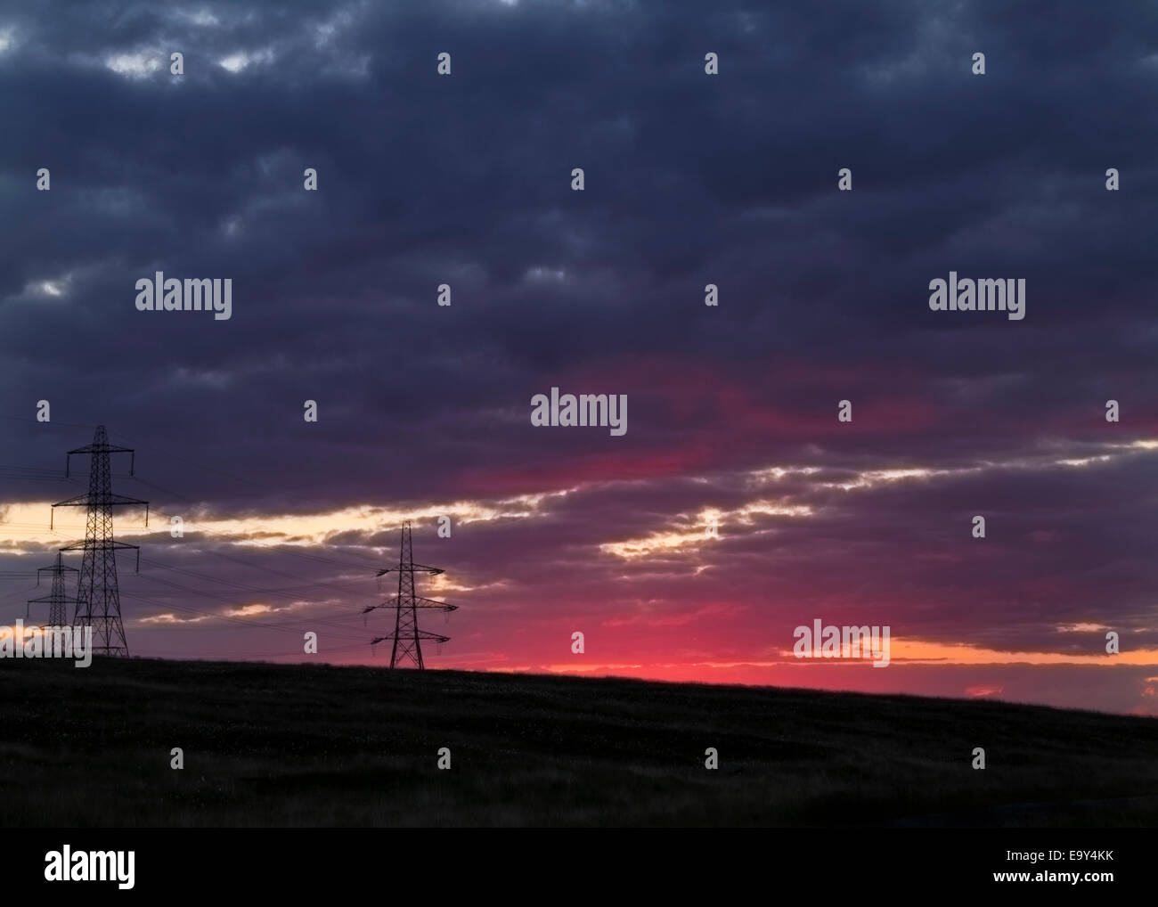 Sunset on the moors with pylons Stock Photo - Alamy