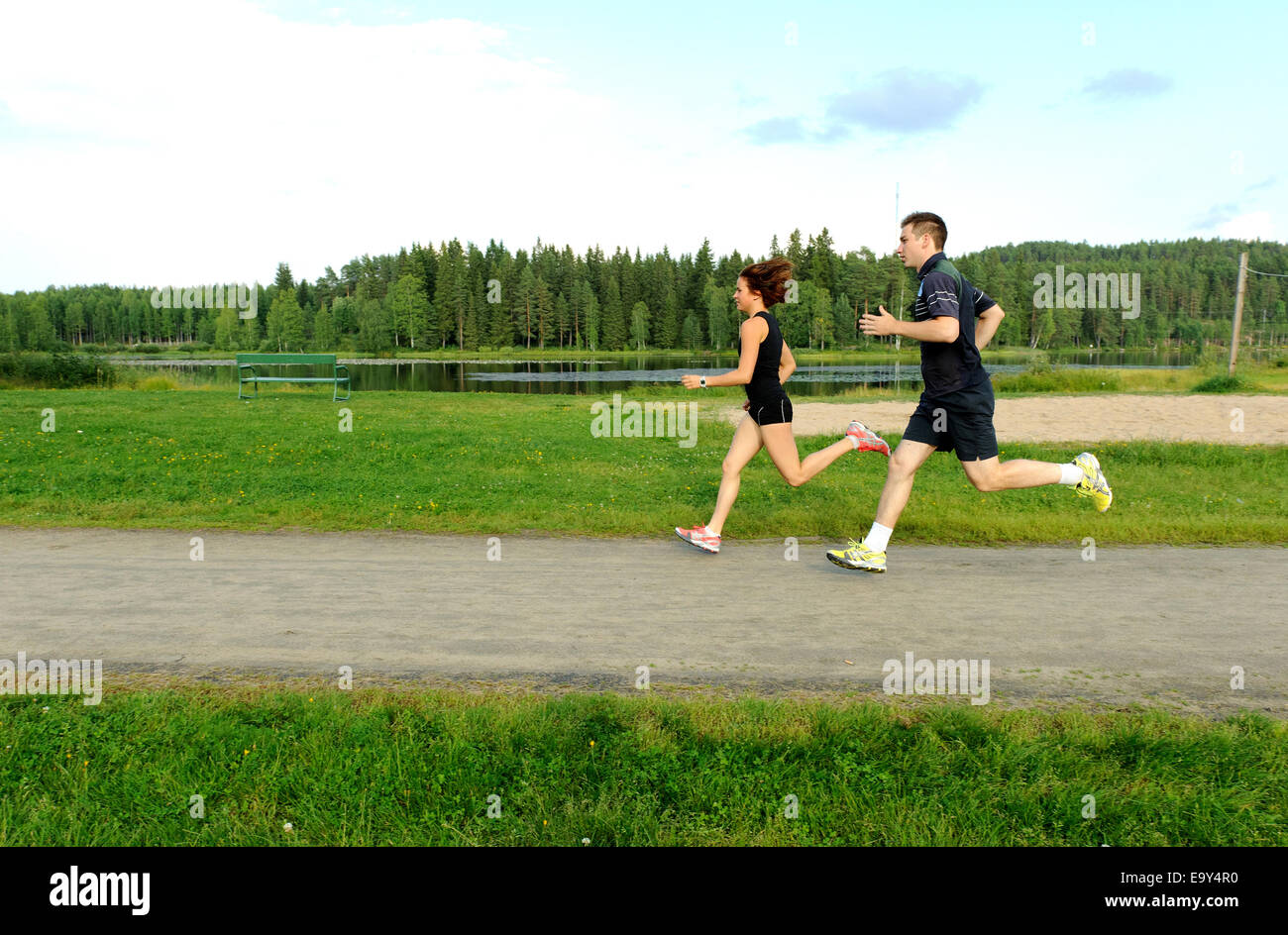 Young couple running outside Stock Photo - Alamy