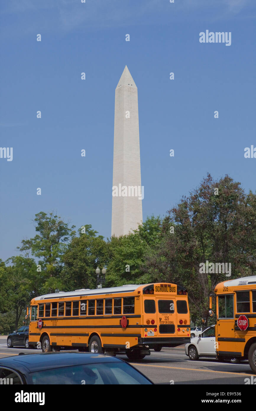 The Washington Monument Street view School buses Stock Photo - Alamy