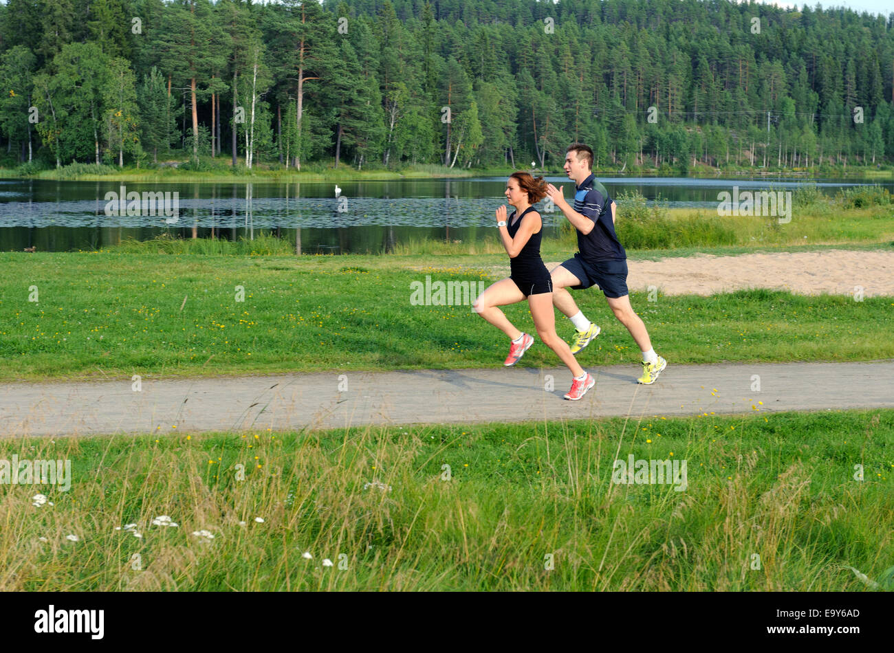 Young couple running outside Stock Photo - Alamy