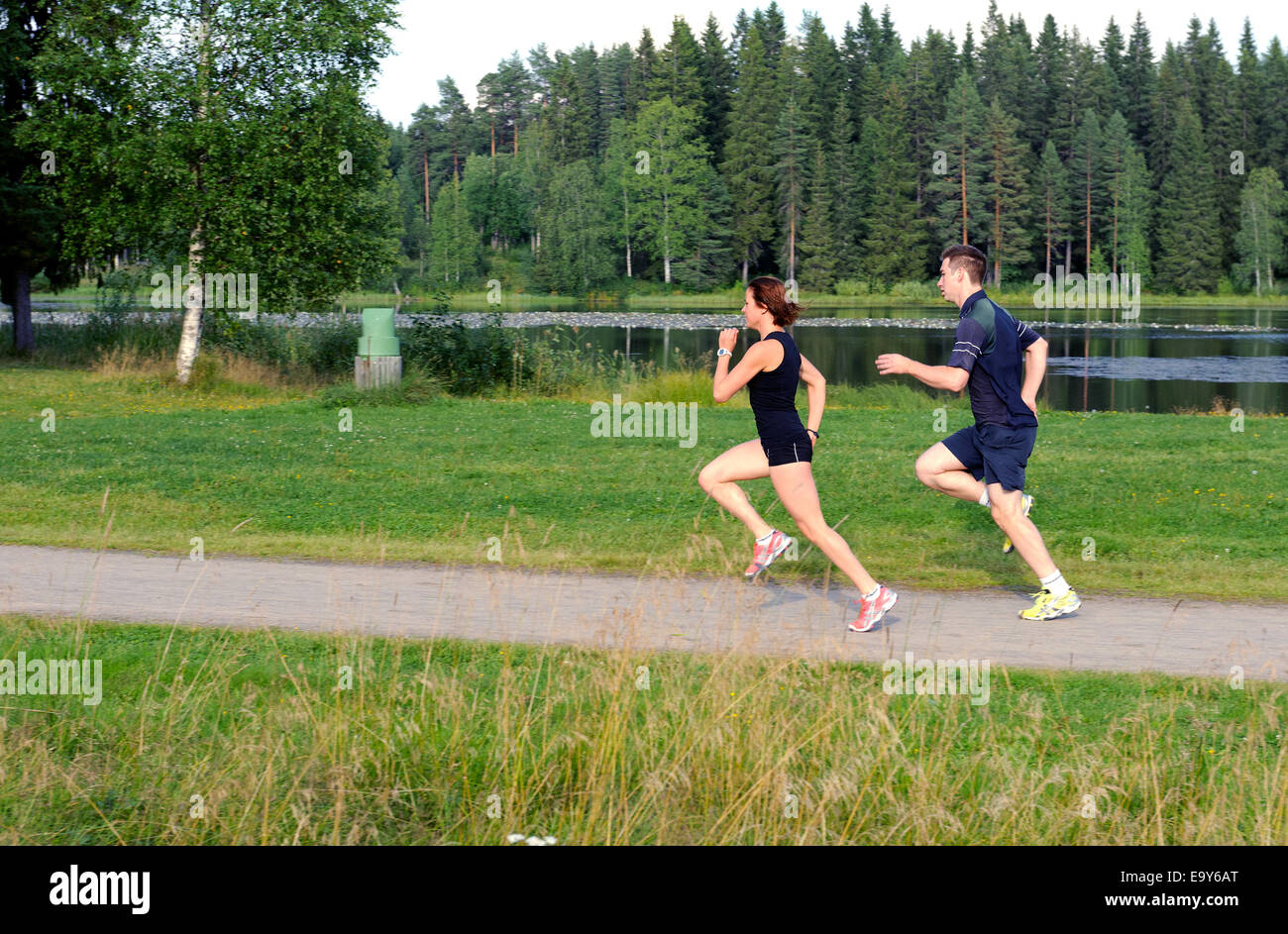Young couple running outside Stock Photo - Alamy