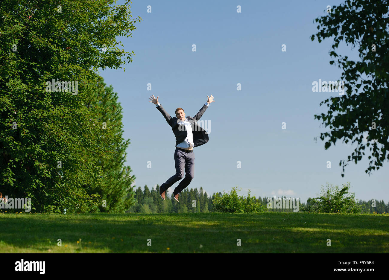 Young man jumping outside Stock Photo - Alamy