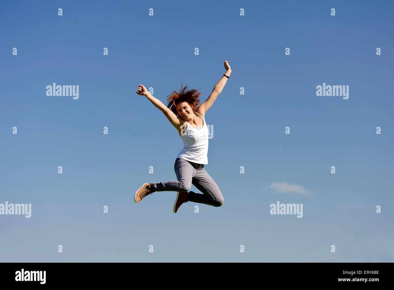 Young woman jumping outside Stock Photo - Alamy