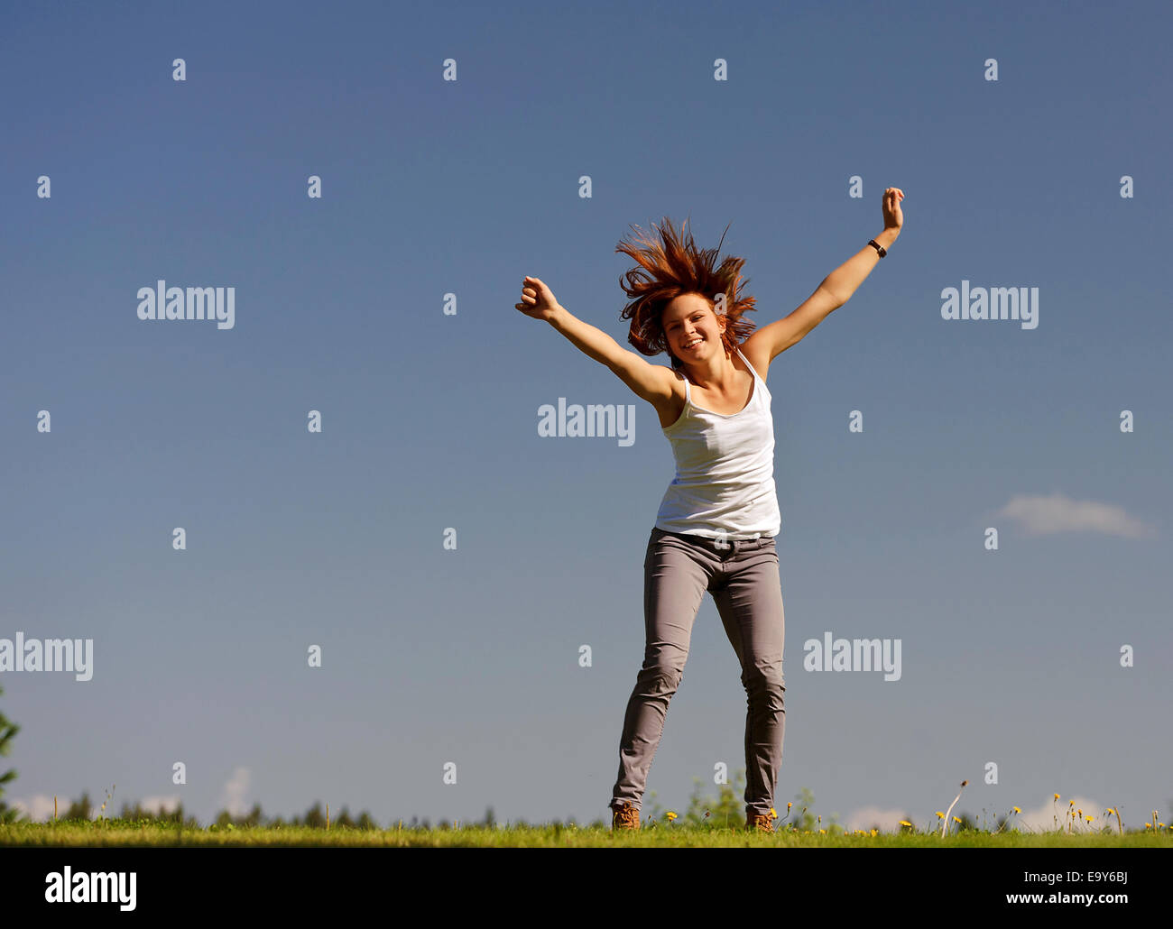 Young woman jumping outside Stock Photo - Alamy