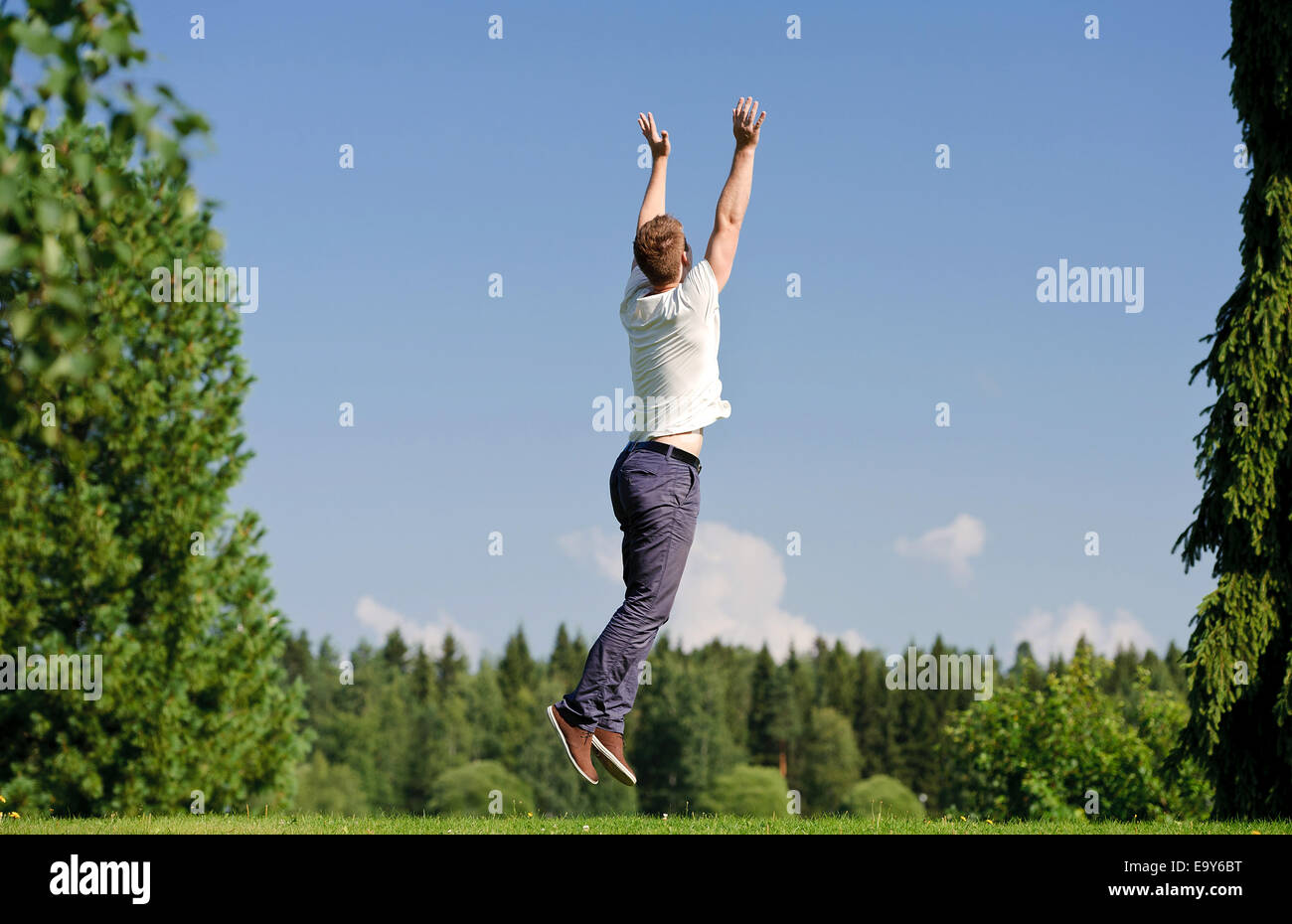 Young man jumping outside Stock Photo - Alamy