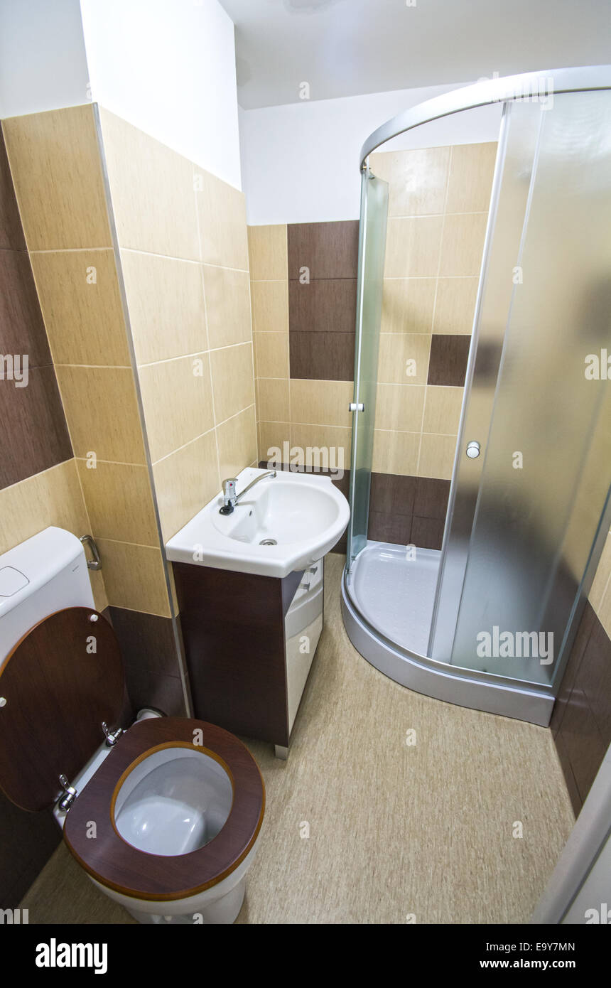 Small hotel bathroom with shower cabin Stock Photo - Alamy
