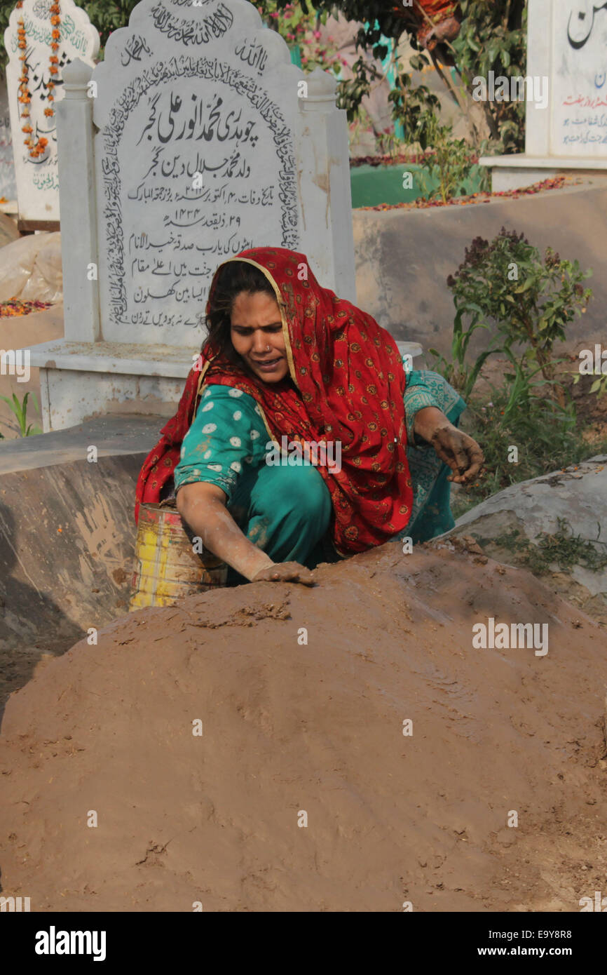 Pakistani people cleans their loved ones graveyard on 9th Muharram at ...