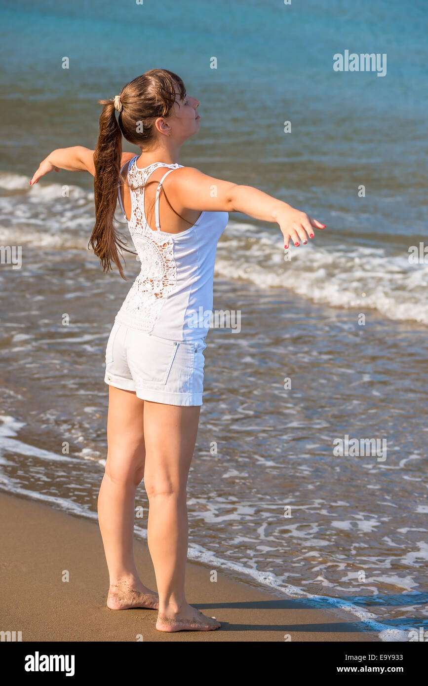 beautiful brunette woman with outstretched hands to the side Stock ...