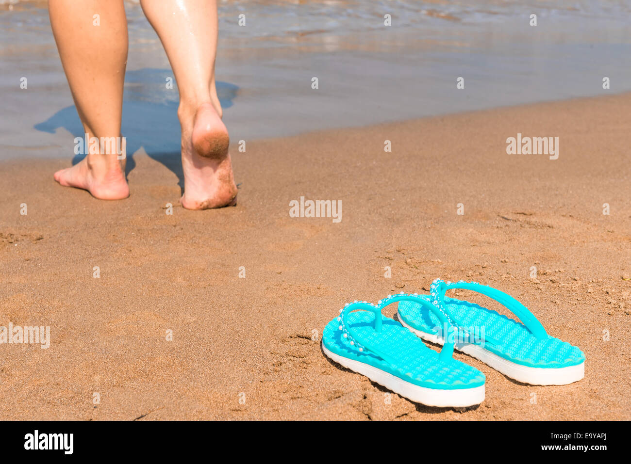 barefoot girl goes without shoes to the sea Stock Photo - Alamy