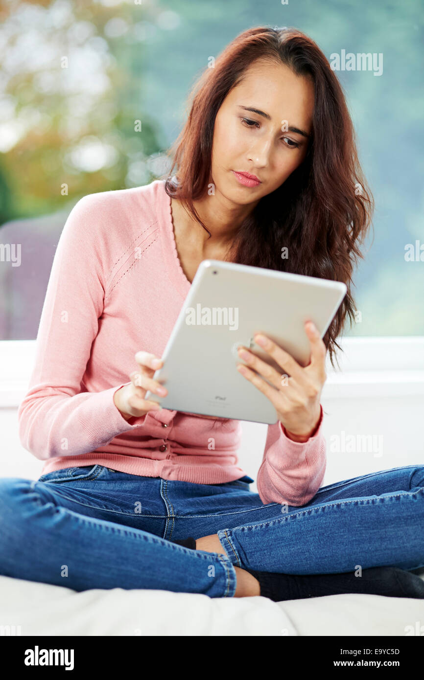 Girl browsing websites using iPad Stock Photo - Alamy