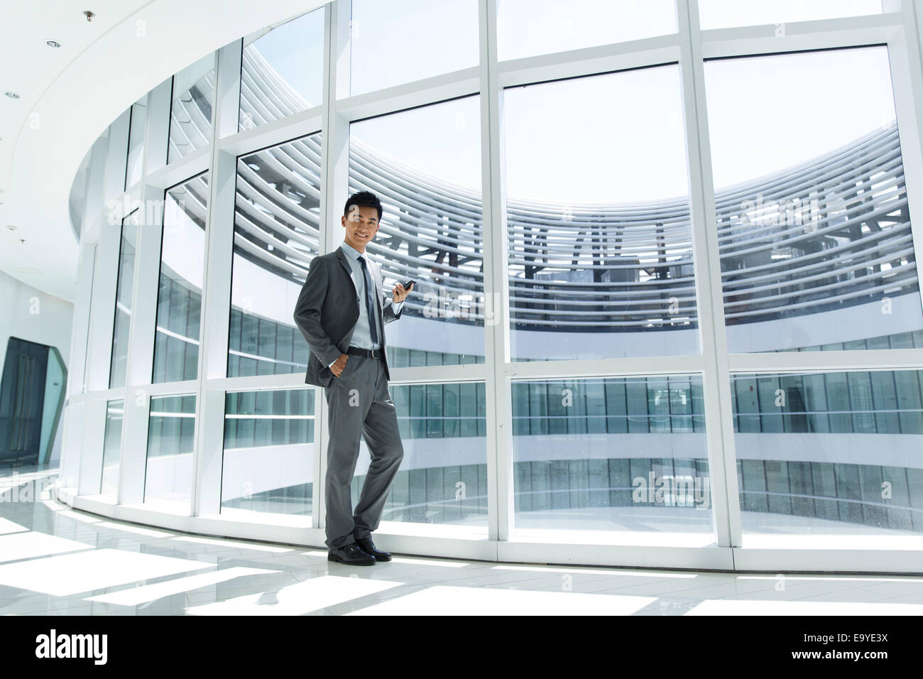 Businessman in office building Stock Photo - Alamy