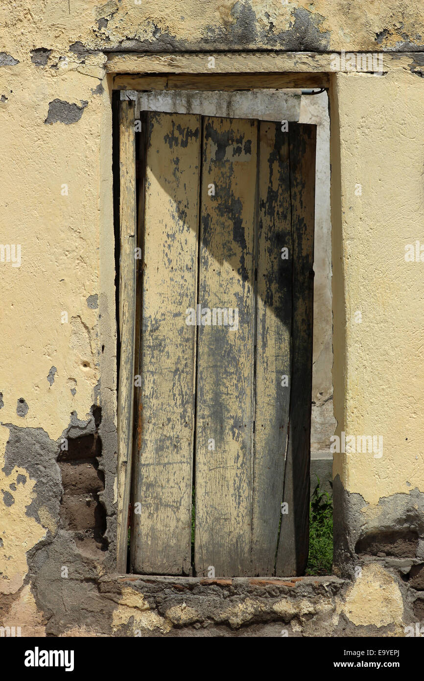 A weathered wood door in a wall on a property in Cotacachi, Ecuador ...