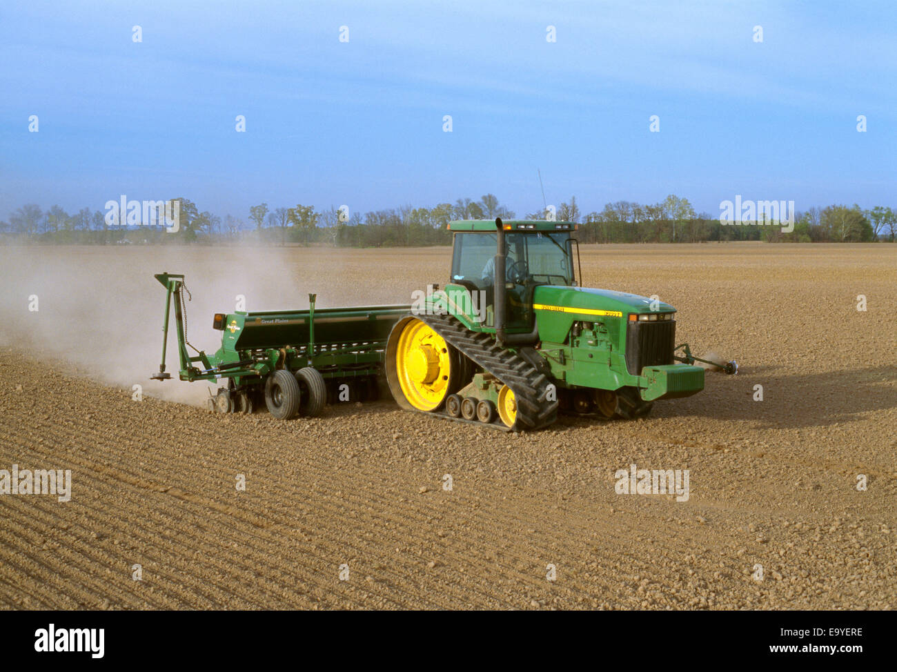 Agriculture - A John Deere tracked tractor and grain drill drilling ...