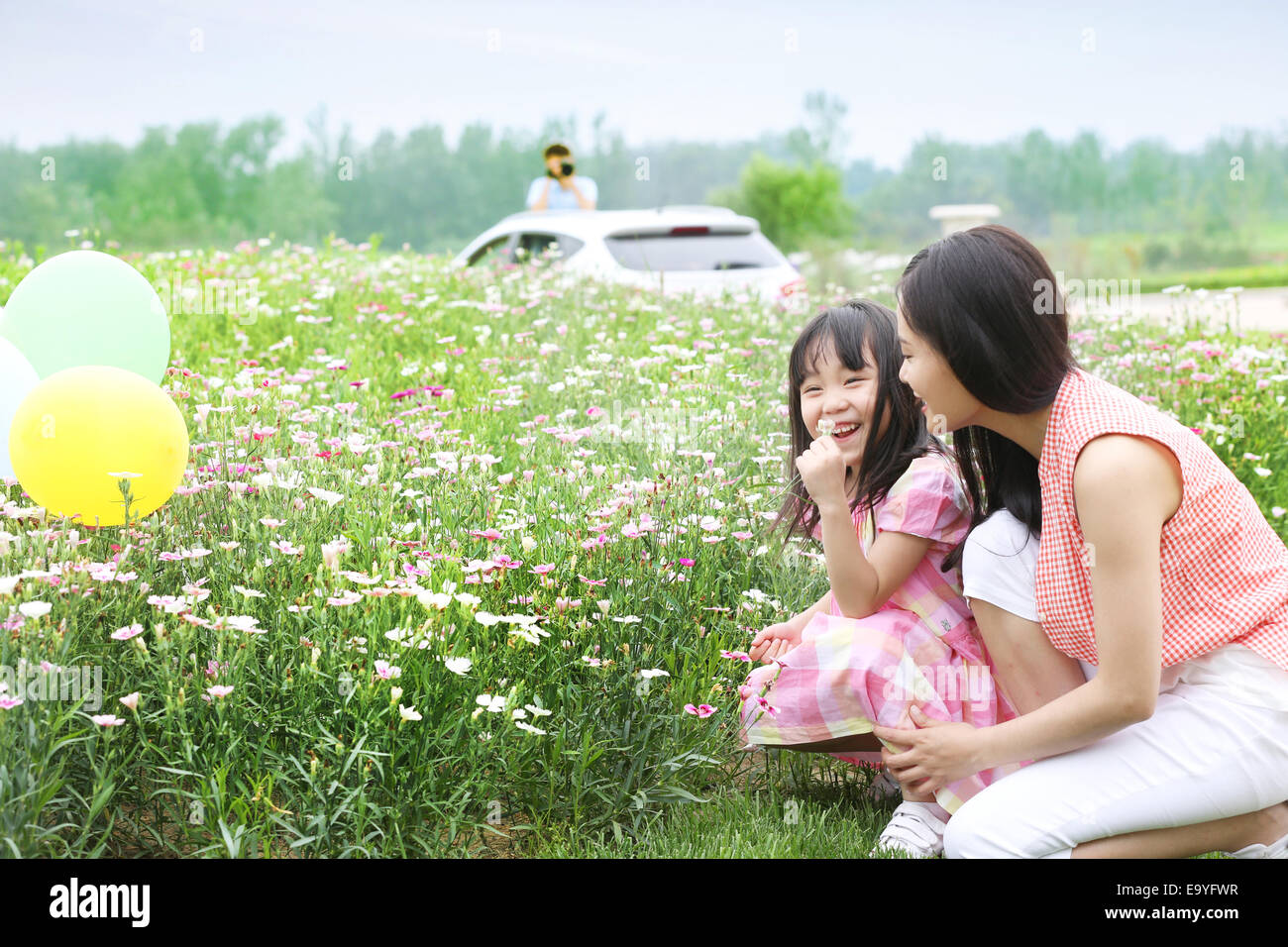 Girl with parents Stock Photo - Alamy