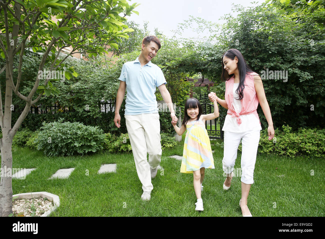 Girl with parents Stock Photo - Alamy
