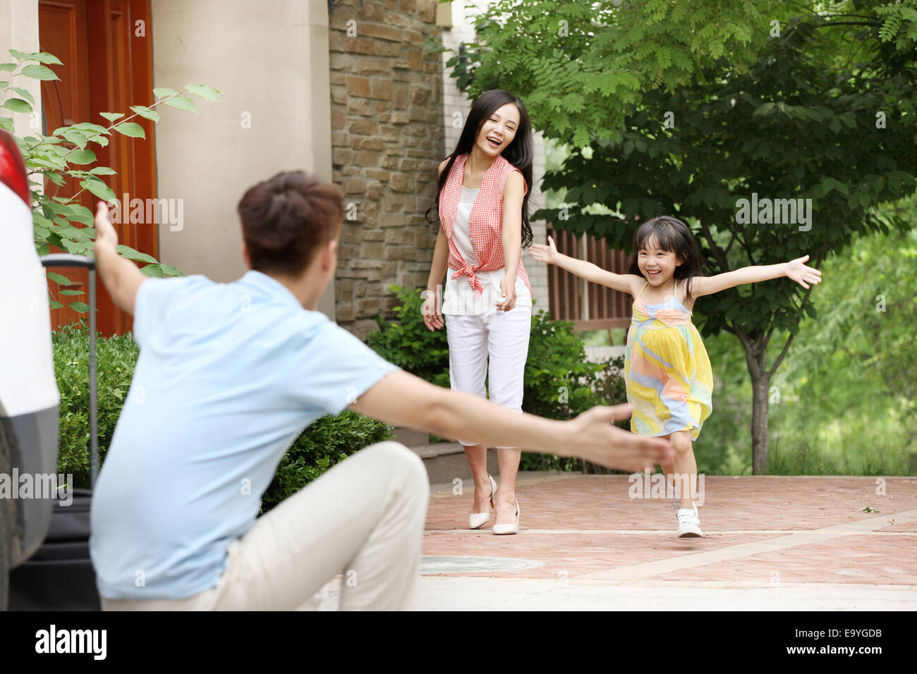 Girl with parents Stock Photo - Alamy