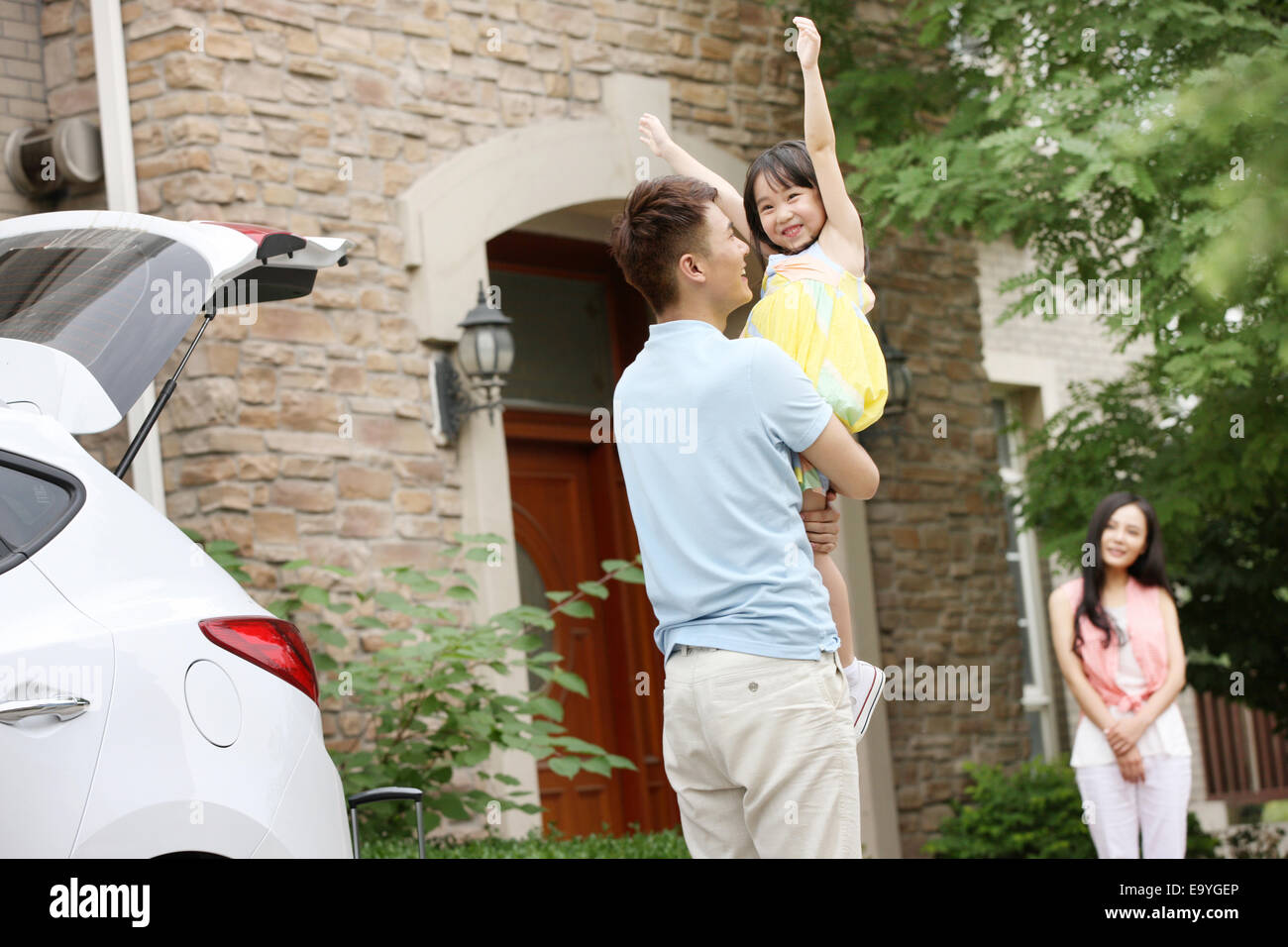 Girl with parents Stock Photo - Alamy