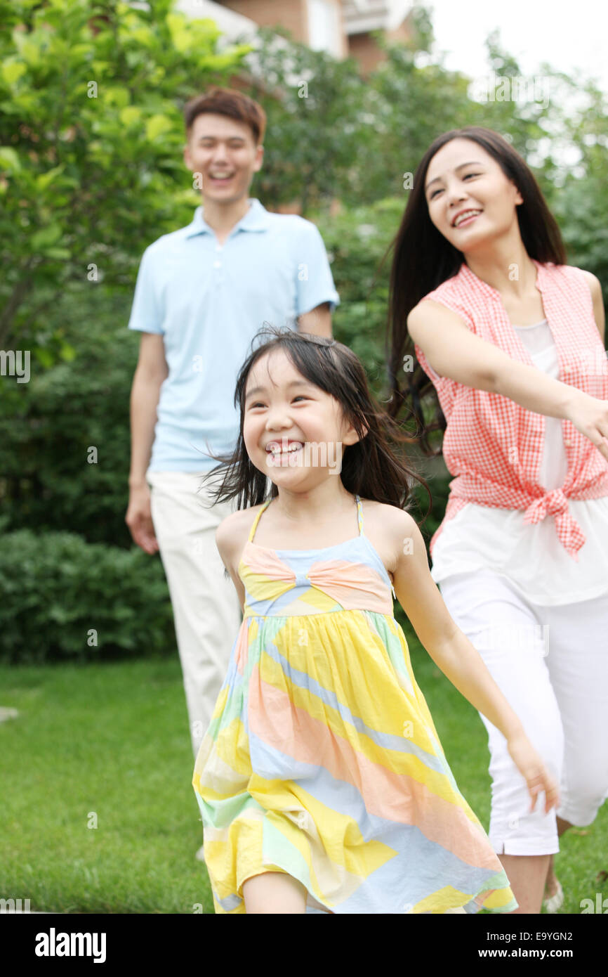 Girl with parents Stock Photo - Alamy